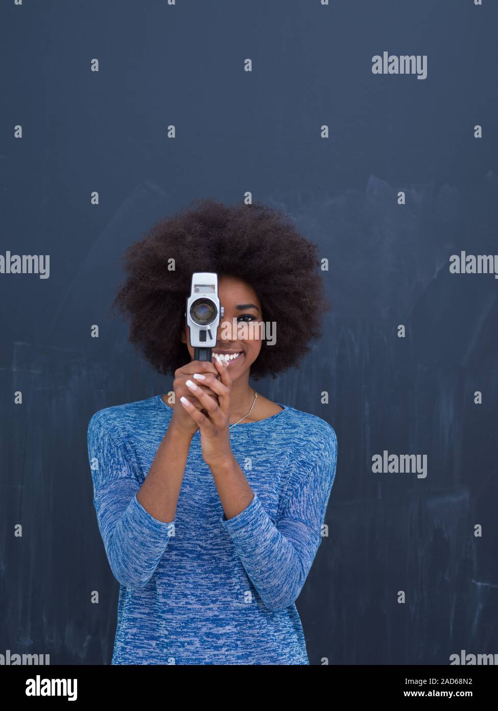 african american woman using a retro video camera Stock Photo - Alamy