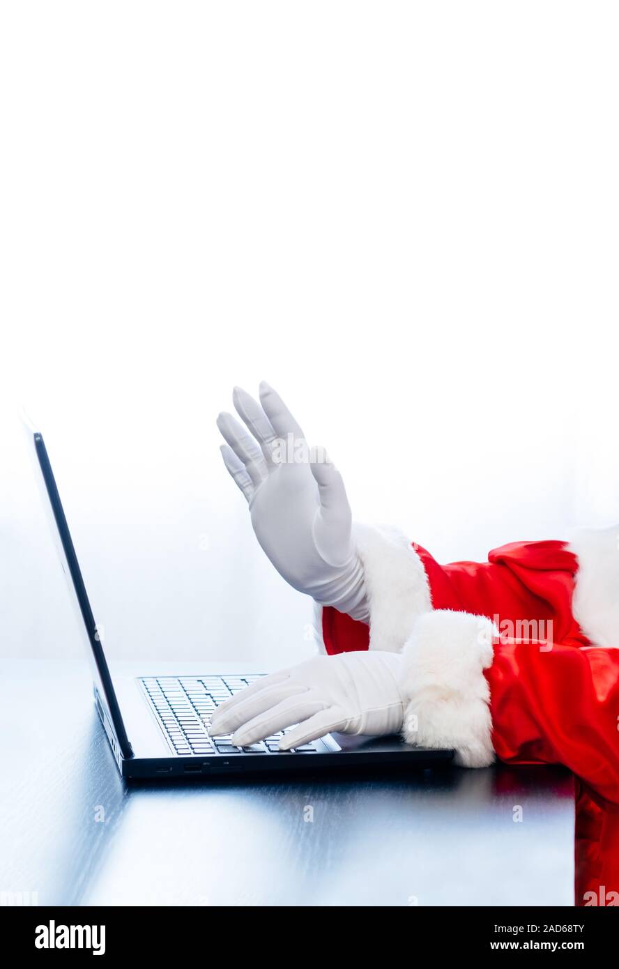 Santa Claus using laptop on the white background. Dressed in white ...