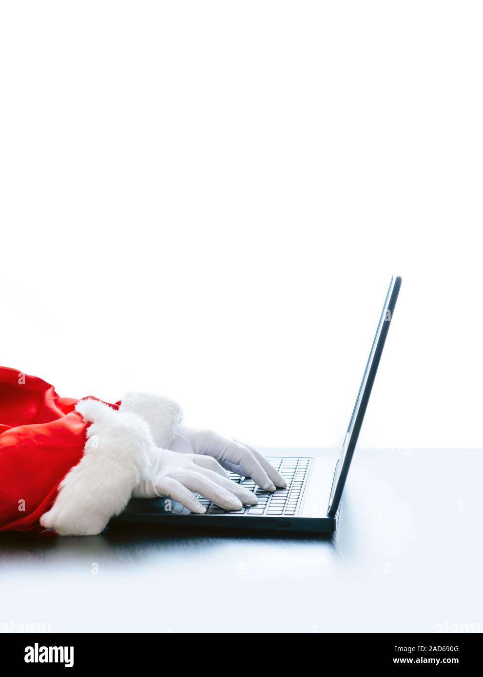 Santa Claus using laptop on the white background. Dressed in white ...