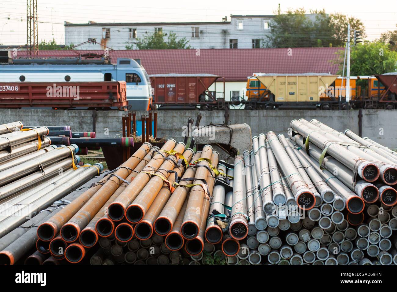Metal rolling. Pipes folded in a railway warehouse are being prepared ...