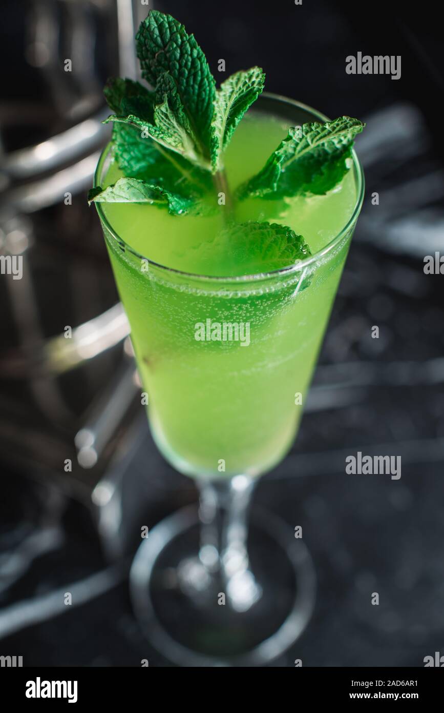 Green Alcoholic Cocktail on bar desk. Mint on top Stock Photo - Alamy