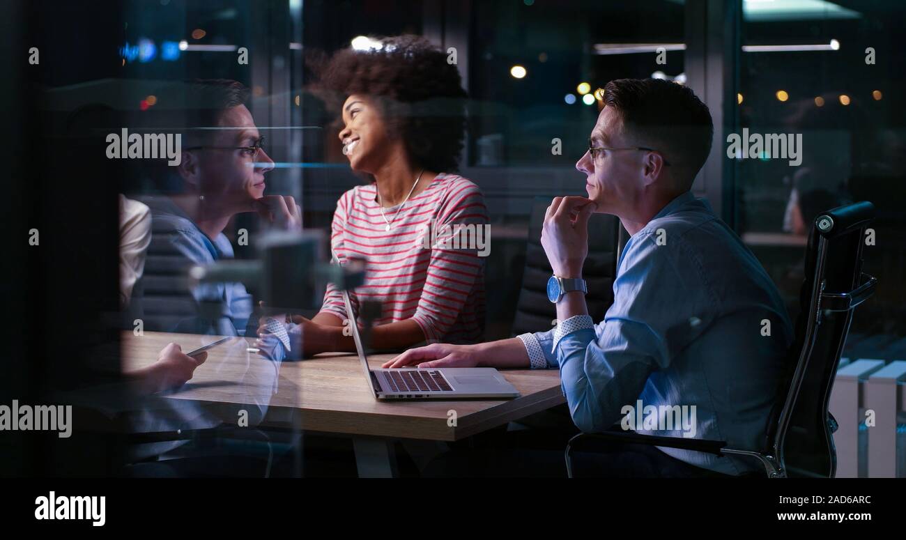 Multiethnic startup Business team in night office Stock Photo - Alamy