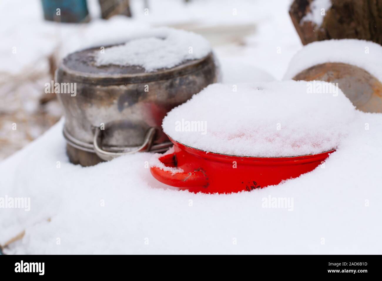 Old pots covered with snow on the street in winter Stock Photo - Alamy
