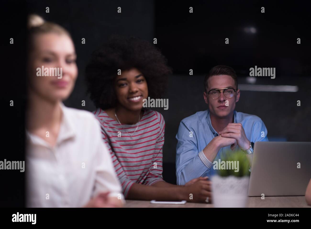 Multiethnic startup Business team in night office Stock Photo - Alamy