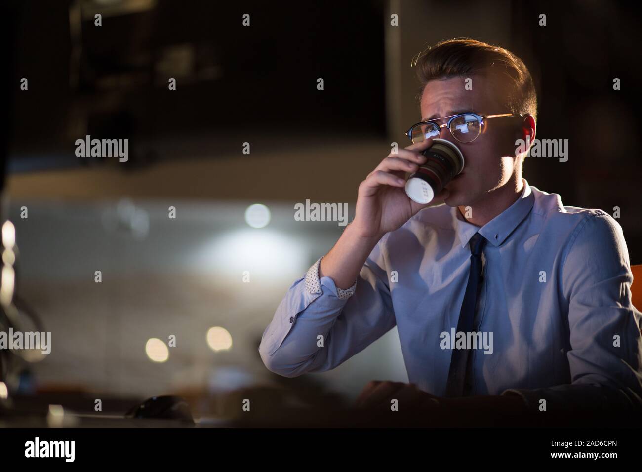 Tired Businessman working late Stock Photo - Alamy