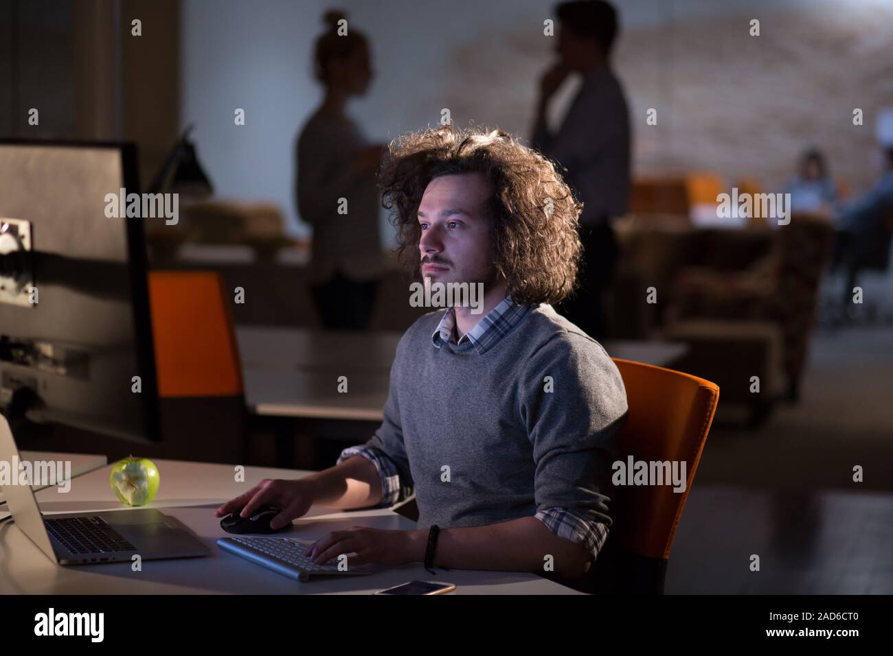 Young man working in office late night hi-res stock photography and ...