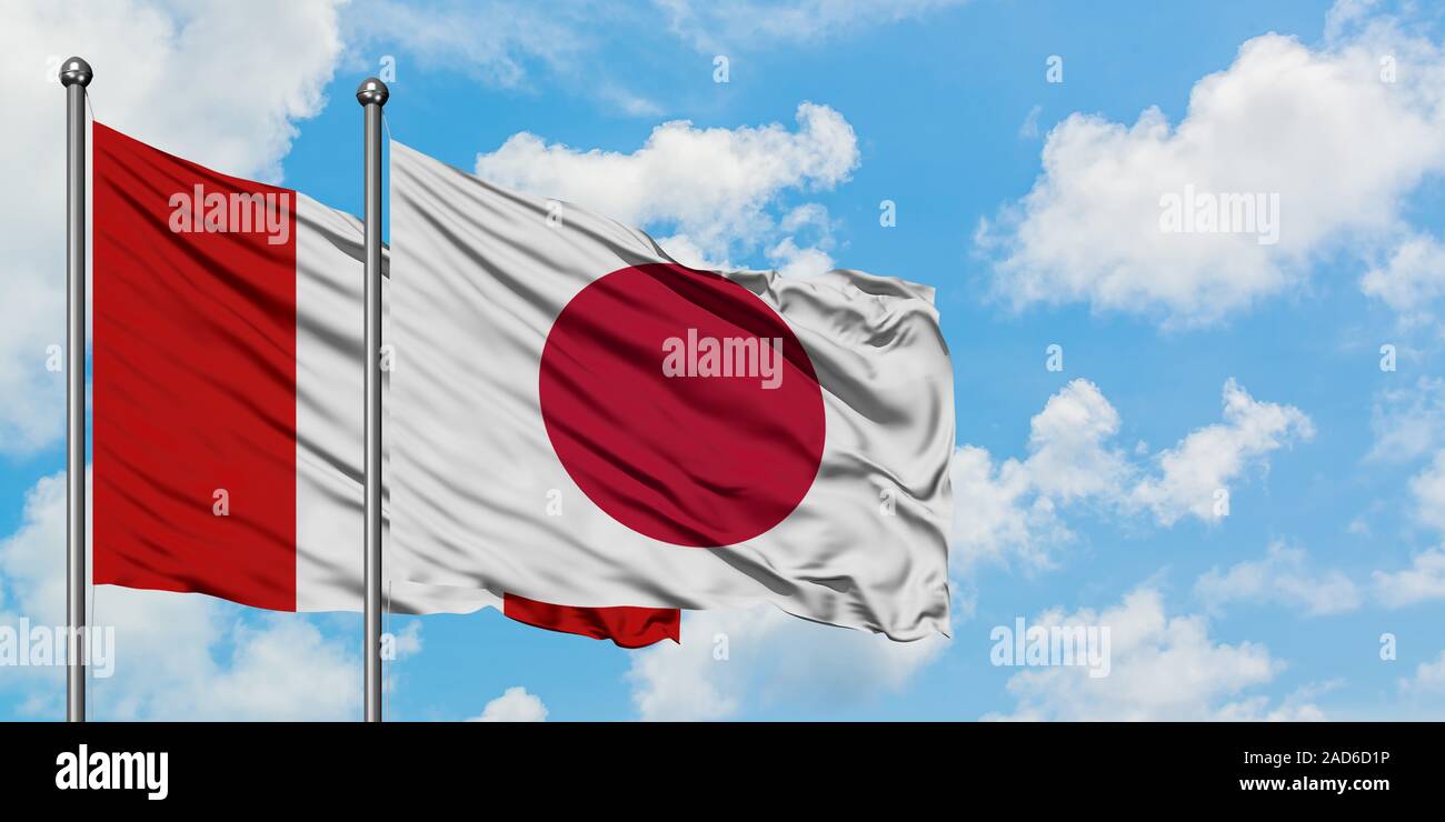 Peru and Japan flag waving in the wind against white cloudy blue sky ...