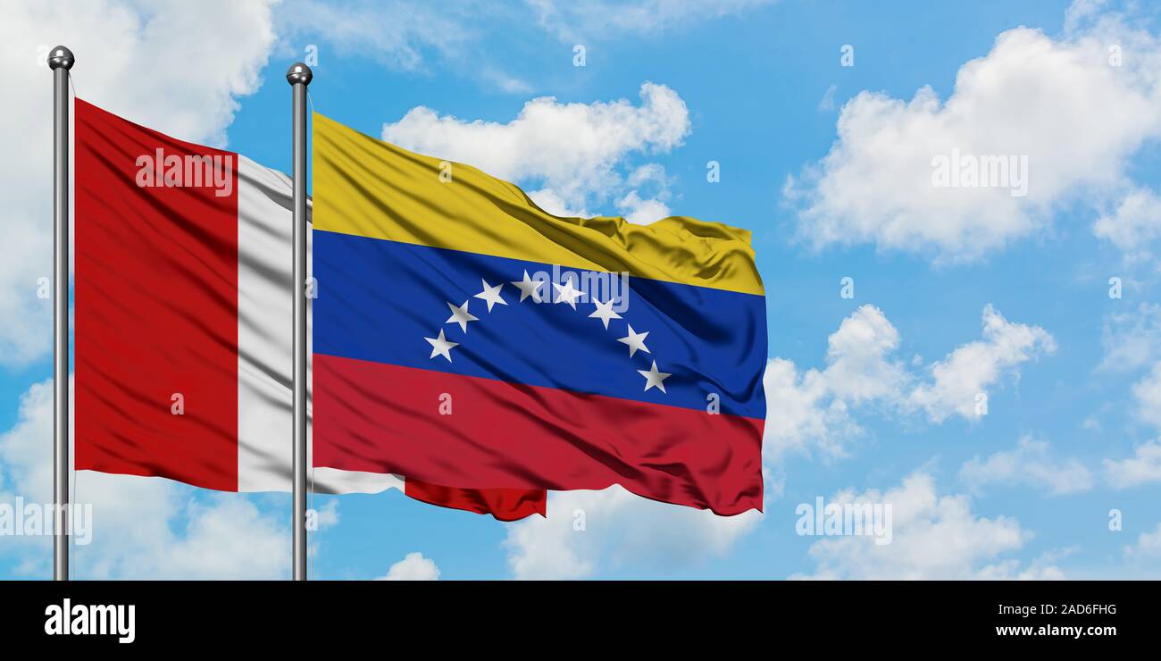 Peru and Venezuela flag waving in the wind against white cloudy blue ...