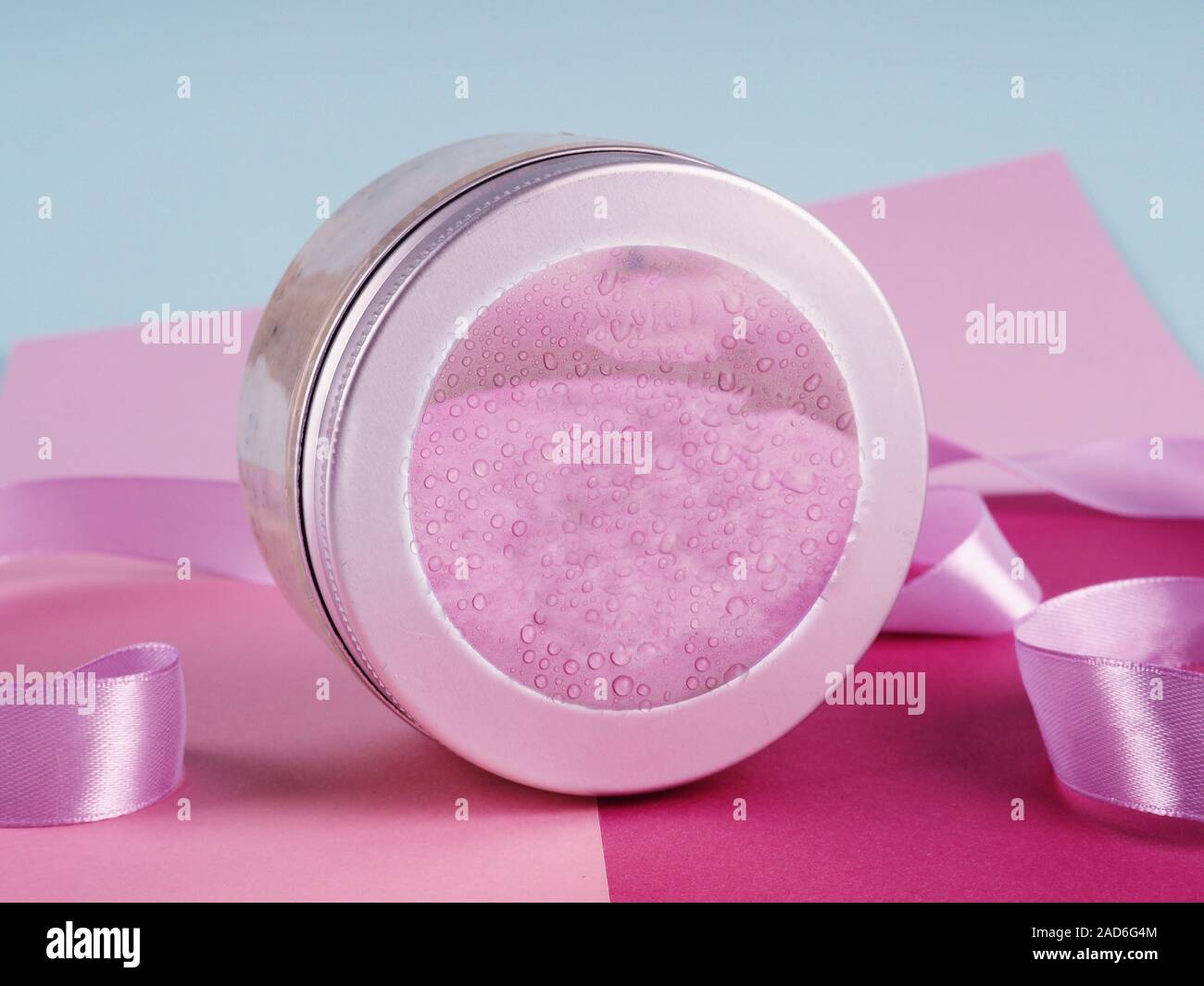 jar with cosmetic, scrub, on a pink background. the concept of delicate ...