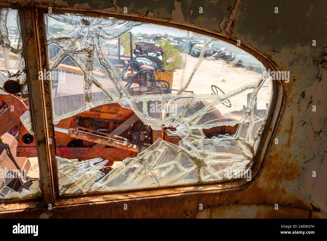 view through wrecked car window in a junk yard in the desert in Phoenix ...