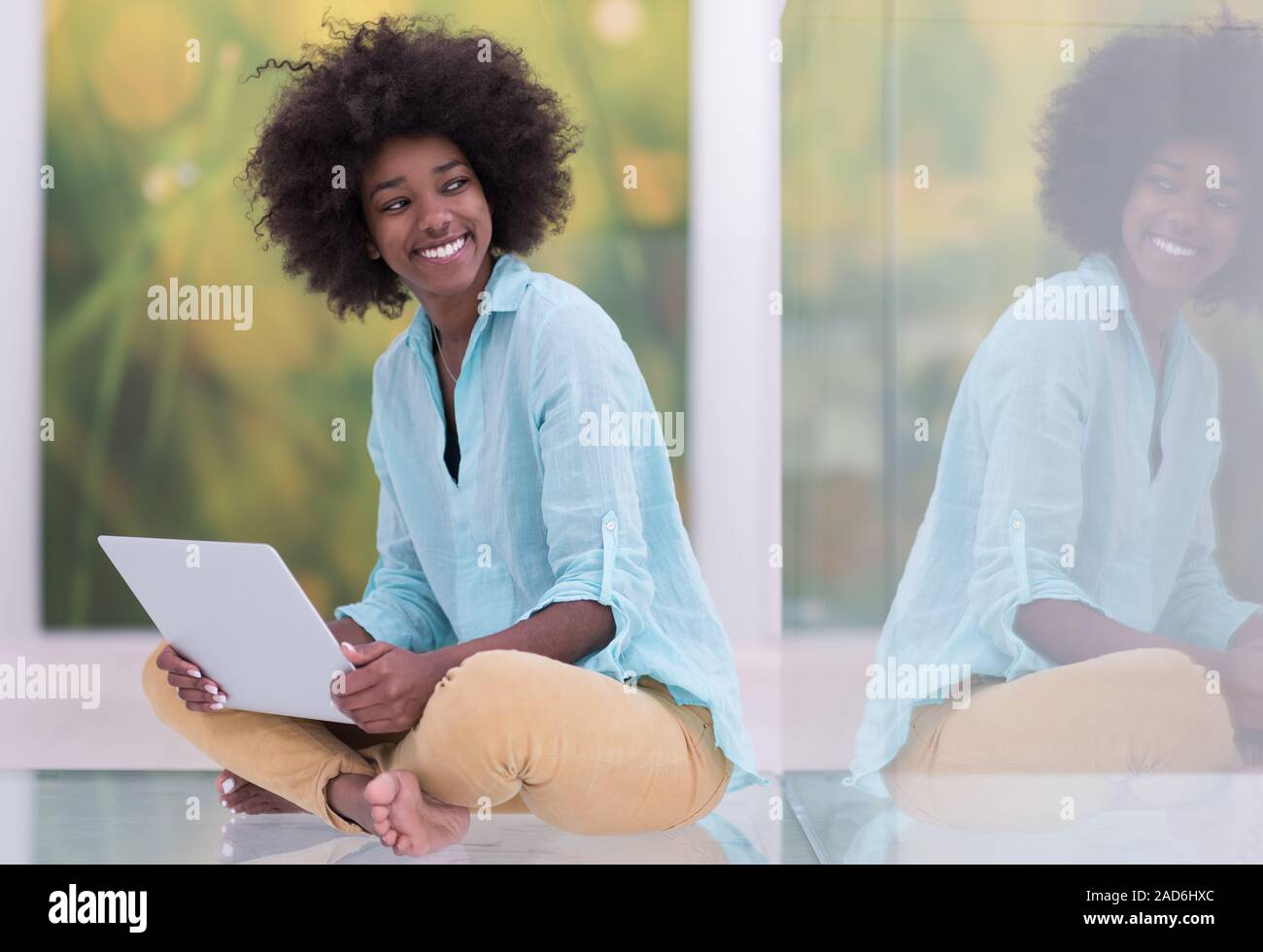 black women using laptop computer on the floor Stock Photo - Alamy