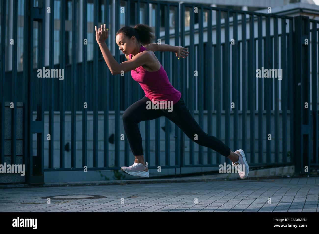 Fit woman running in the street stock photo Stock Photo - Alamy