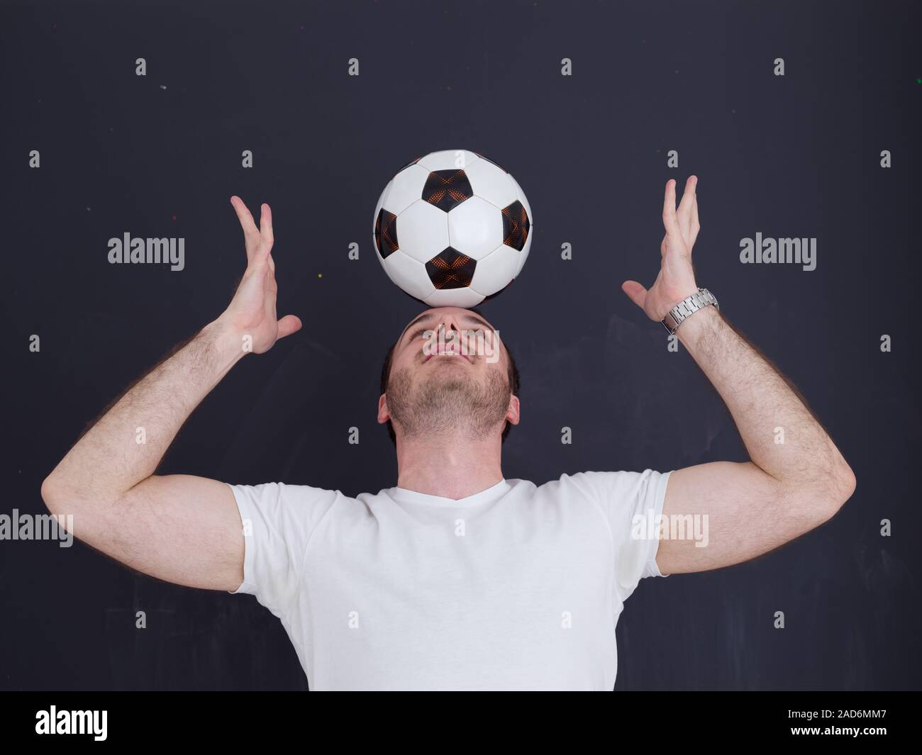 man playing with soccer ball isolated over grey Stock Photo - Alamy