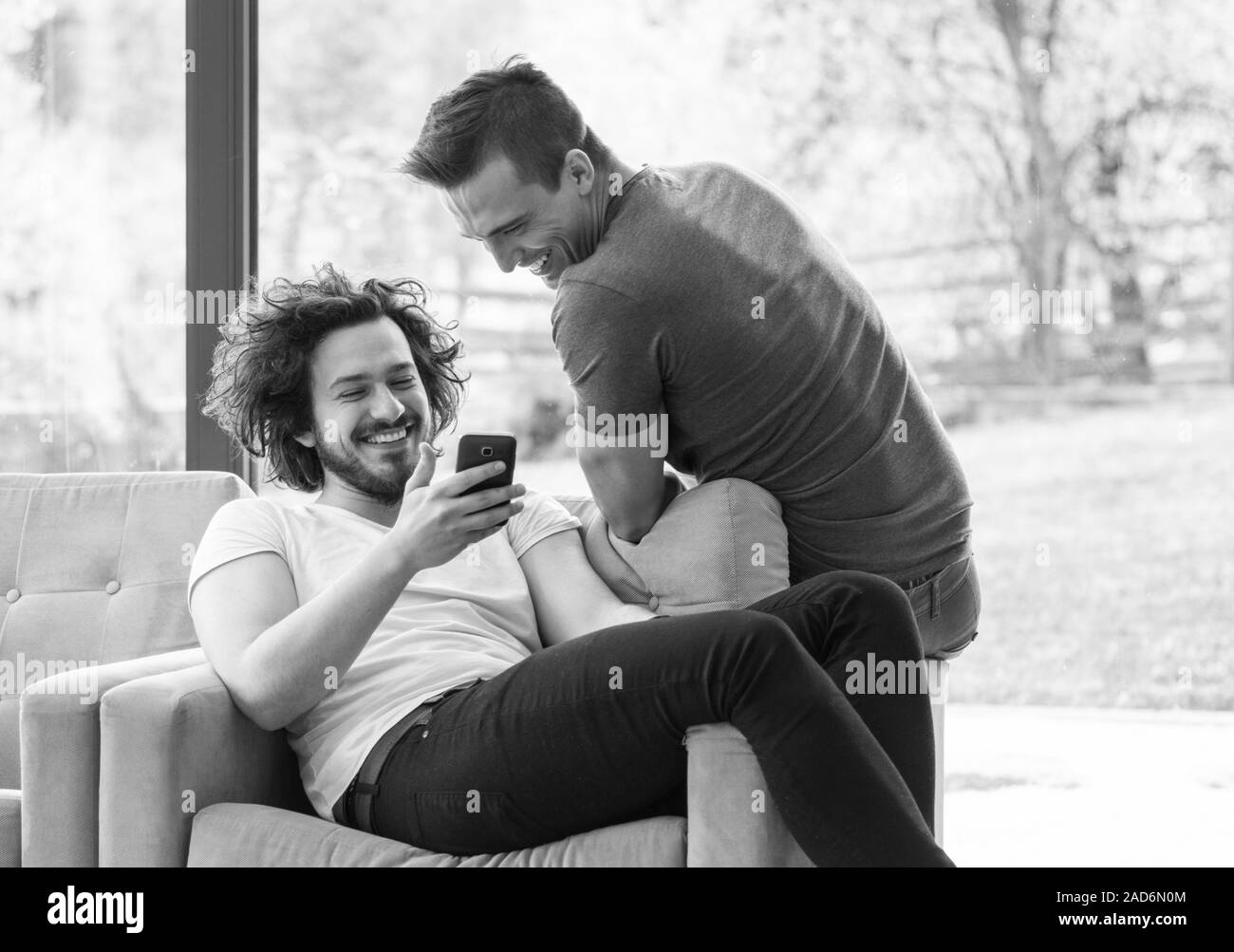 Two friends watching video Stock Photo - Alamy