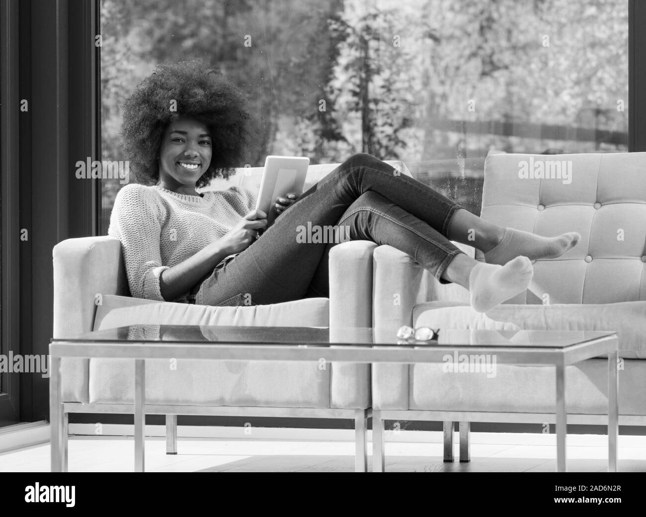Beautifl black girl lying on couch Stock Photo - Alamy