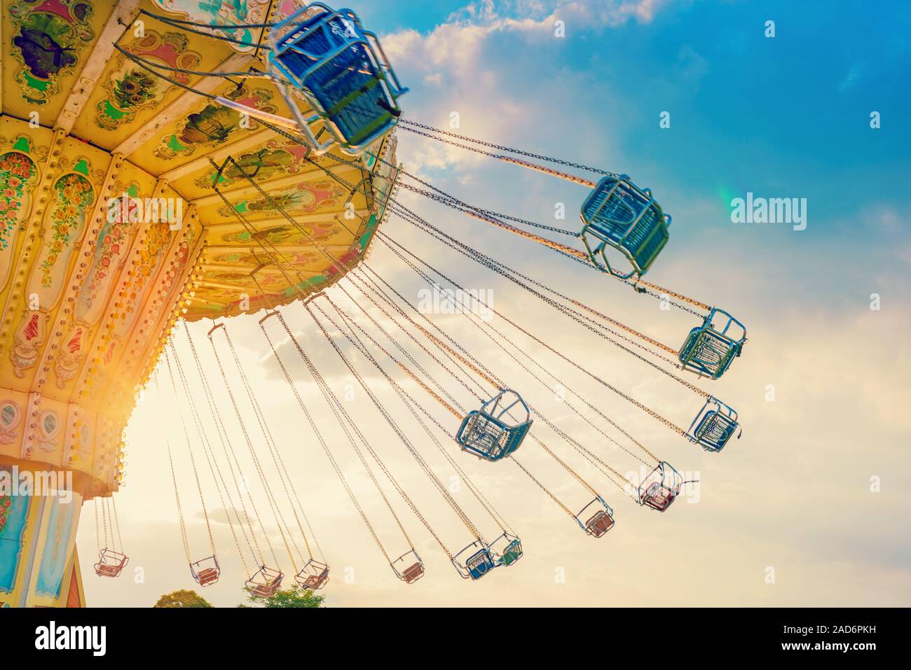 carousel ride spins fast in the air at sunset - a swinging carousel ...
