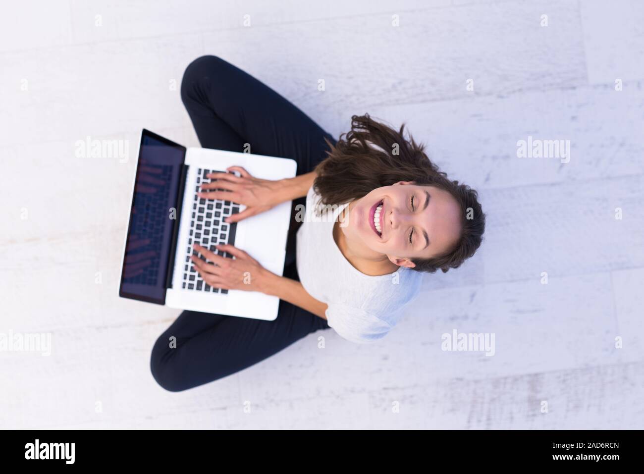 women using laptop computer on the floor top view Stock Photo - Alamy