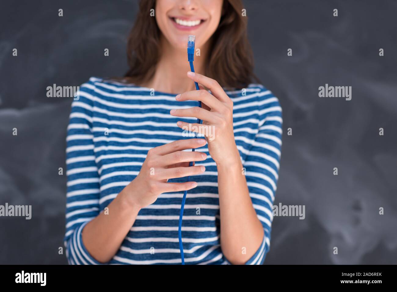 woman holding a internet cable in front of chalk drawing board Stock ...
