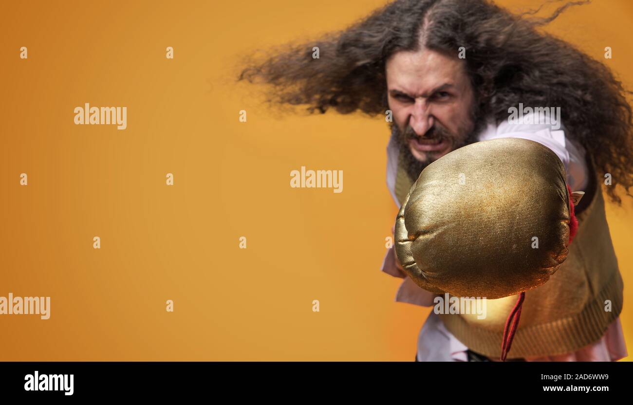Portrait of an eccentric, skinny guy throwing a good punch Stock Photo ...