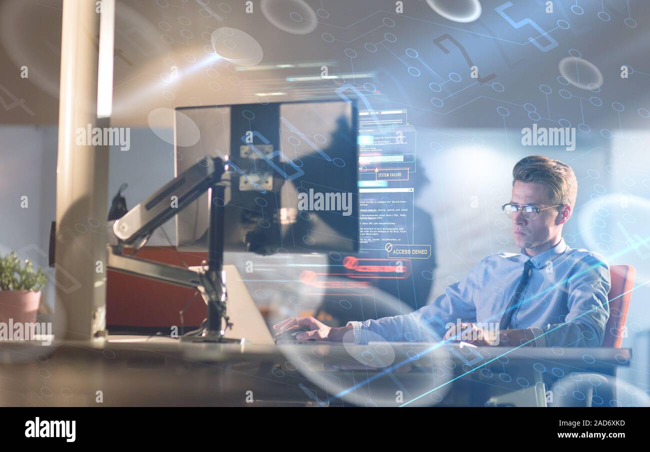 man working on computer in dark office Stock Photo - Alamy