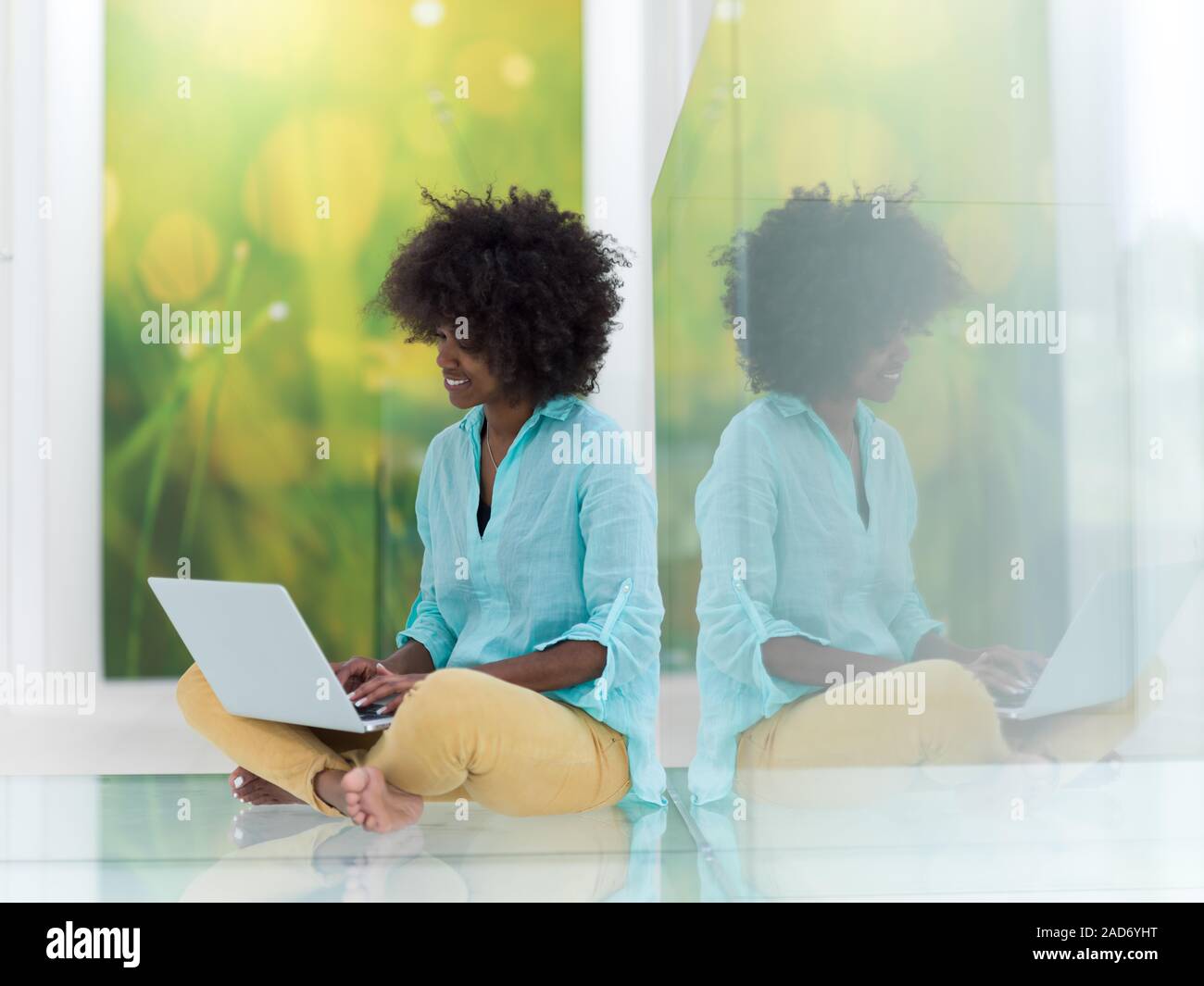 black women using laptop computer on the floor Stock Photo - Alamy