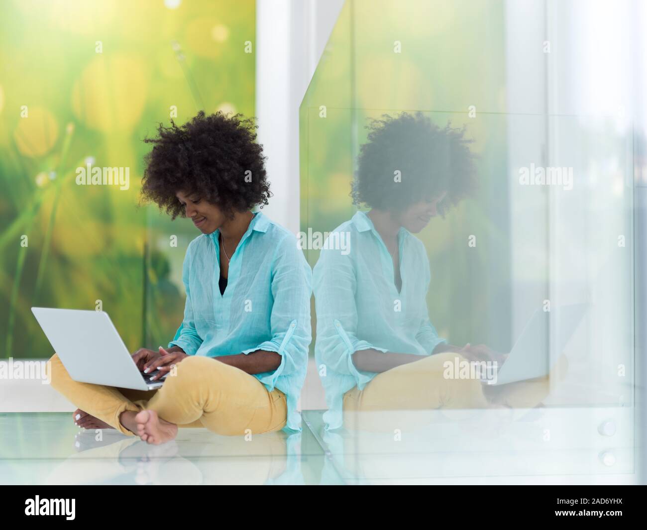 black women using laptop computer on the floor Stock Photo - Alamy