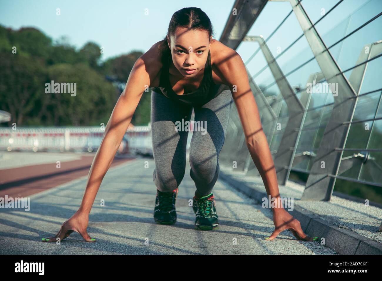 Concentrated sports woman at the crouch start stock photo Stock Photo ...