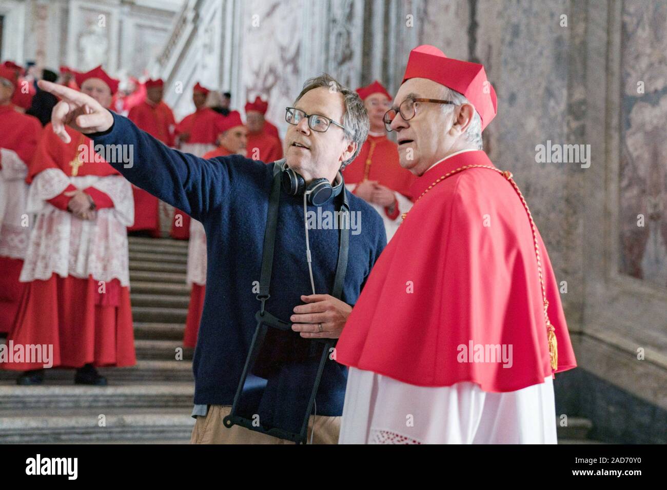 THE TWO POPES, from left: director Fernando Meirelles, Jonathan Pryce ...