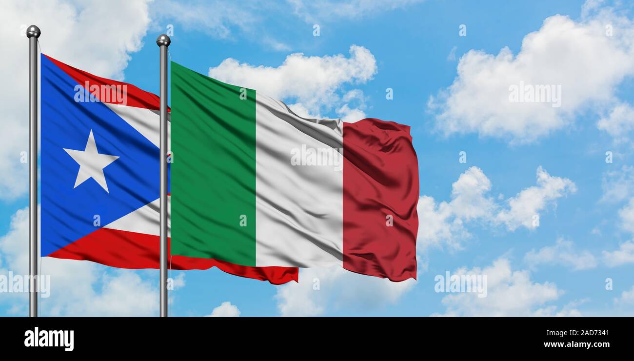 Puerto Rico and Italy flag waving in the wind against white cloudy blue ...