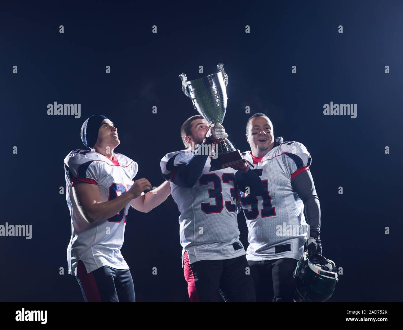 american football team with trophy celebrating victory Stock Photo - Alamy