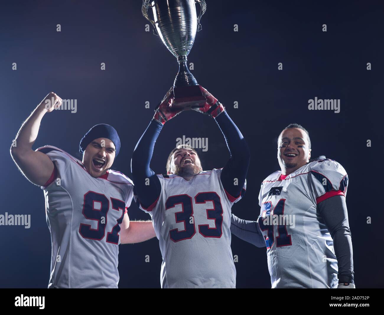 american football team with trophy celebrating victory Stock Photo - Alamy