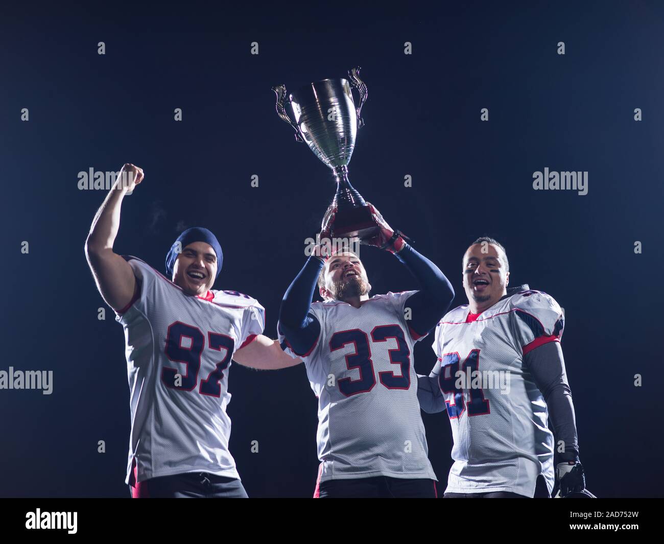 american football team with trophy celebrating victory Stock Photo - Alamy