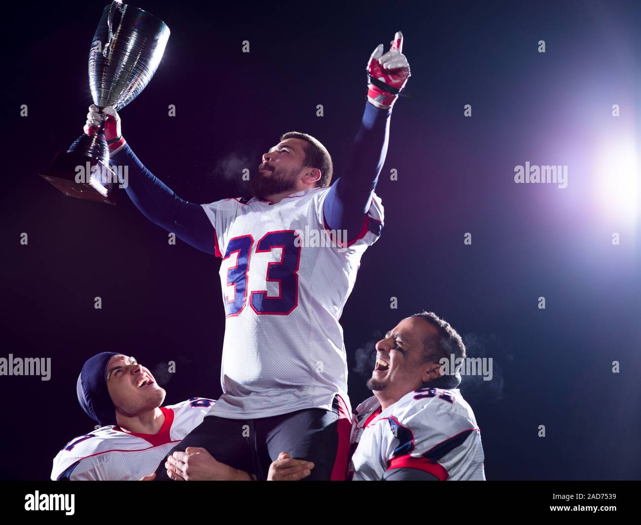 american football team with trophy celebrating victory Stock Photo - Alamy