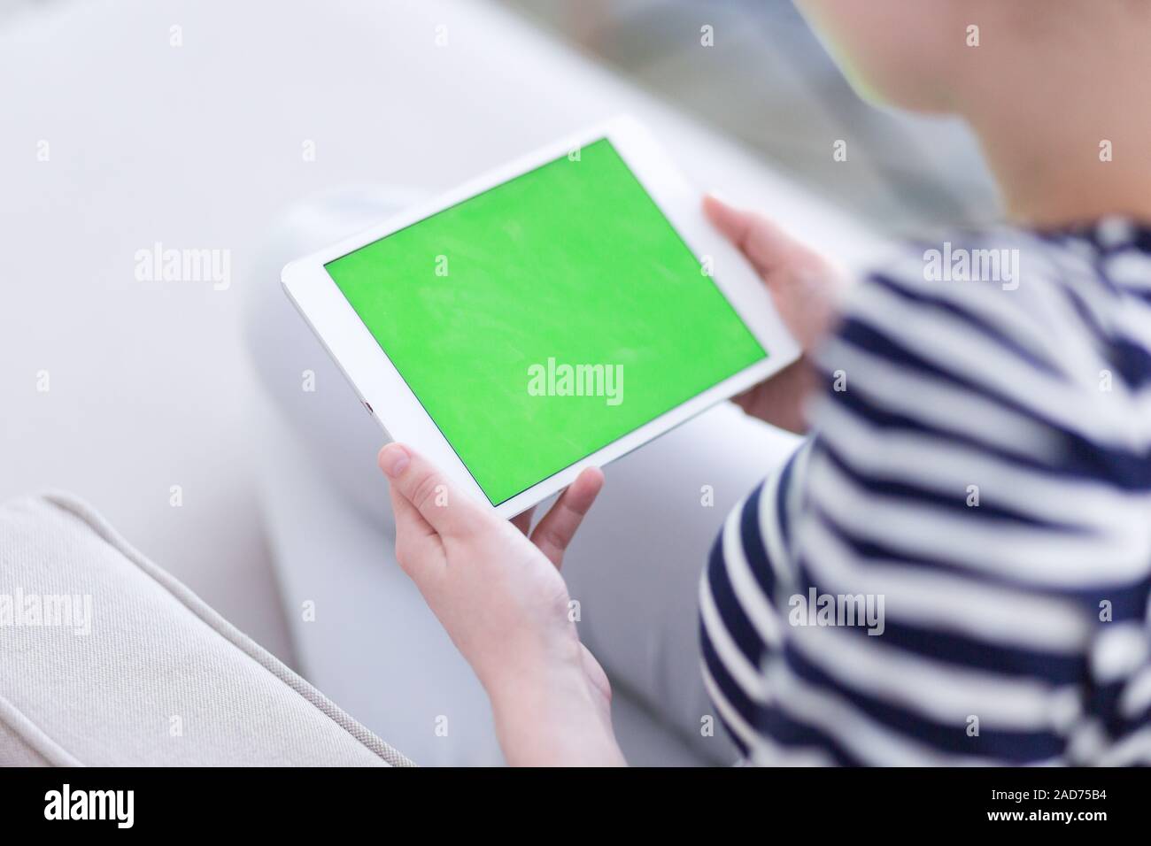 woman on sofa using tablet computer Stock Photo - Alamy