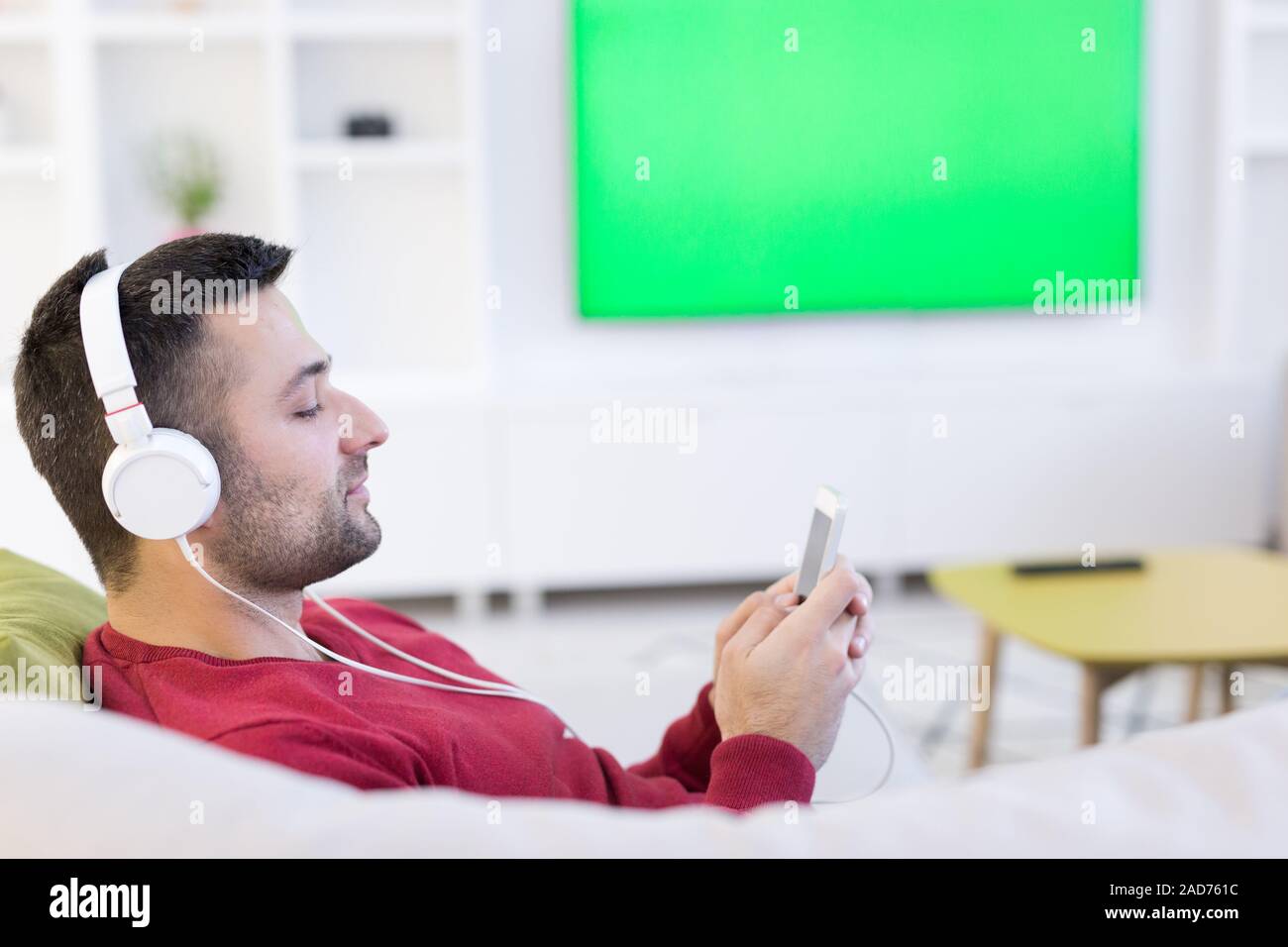 Cheerful guy enjoying music through hi-res stock photography and images ...