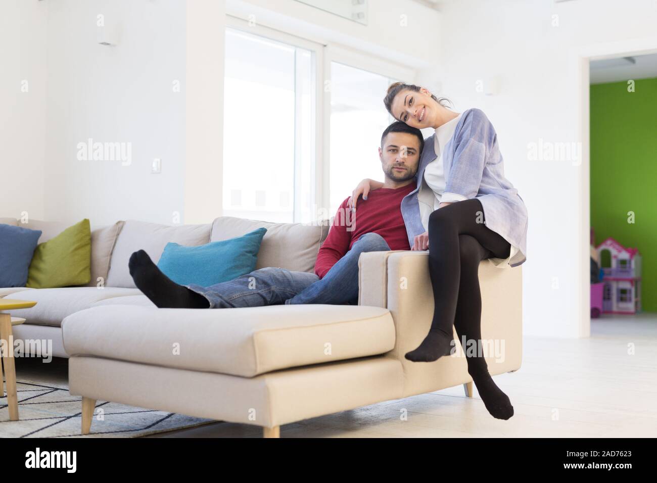 couple hugging and relaxing on sofa Stock Photo - Alamy