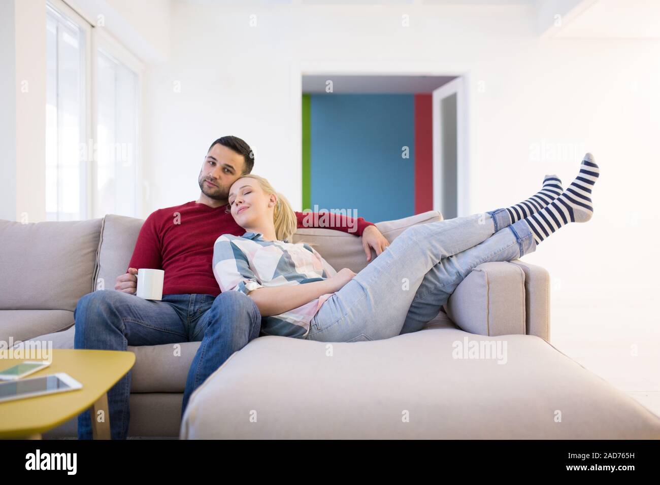 Couple hugging on couch hi-res stock photography and images - Alamy