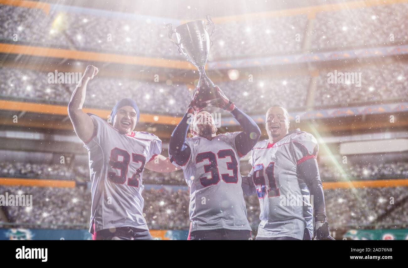 american football team with trophy celebrating victory in the cup final ...