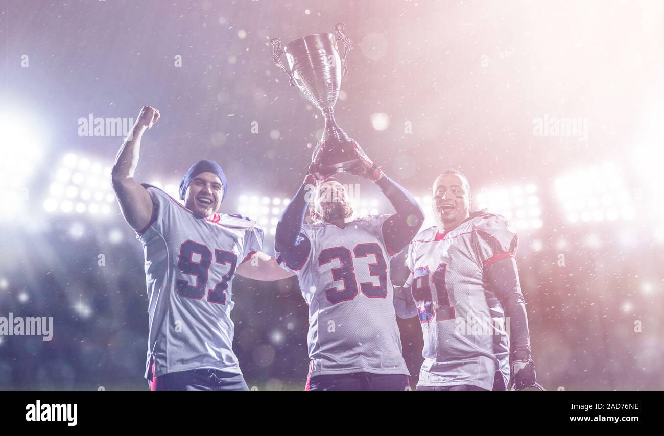 american football team with trophy celebrating victory in the cup final ...