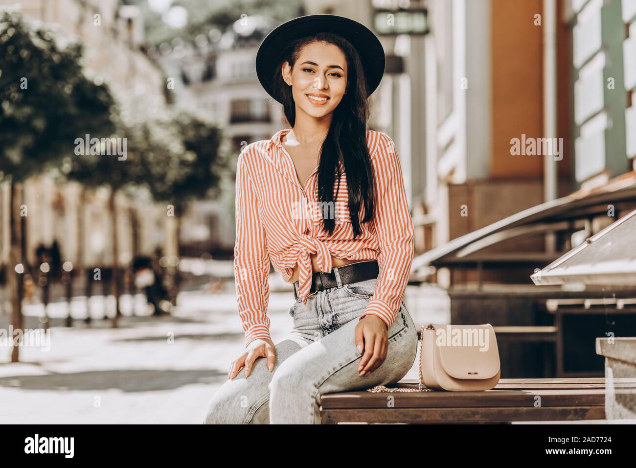 Gladsome smiling woman sitting outdoors stock photo Stock Photo - Alamy