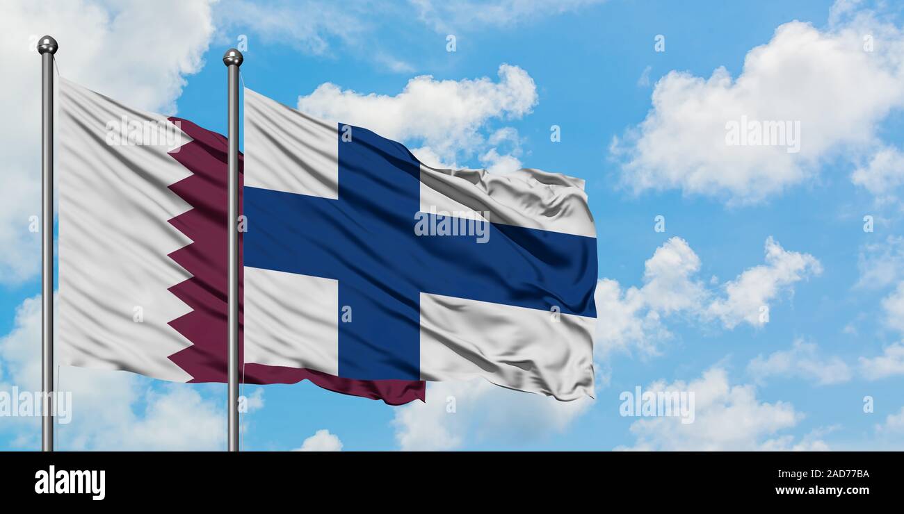 Qatar and Finland flag waving in the wind against white cloudy blue sky ...