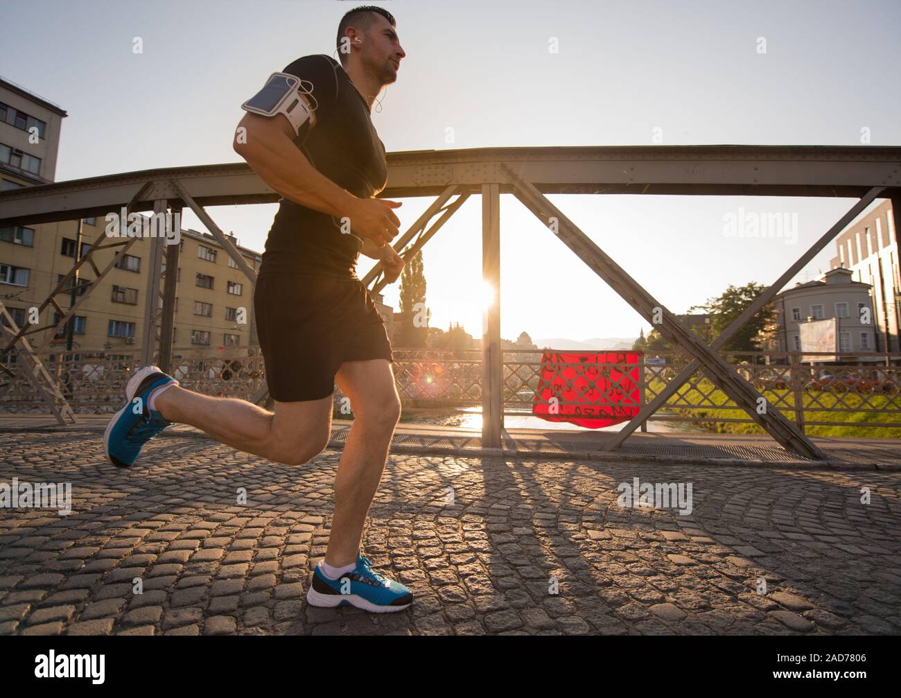 man jogging across the bridge at sunny morning Stock Photo - Alamy