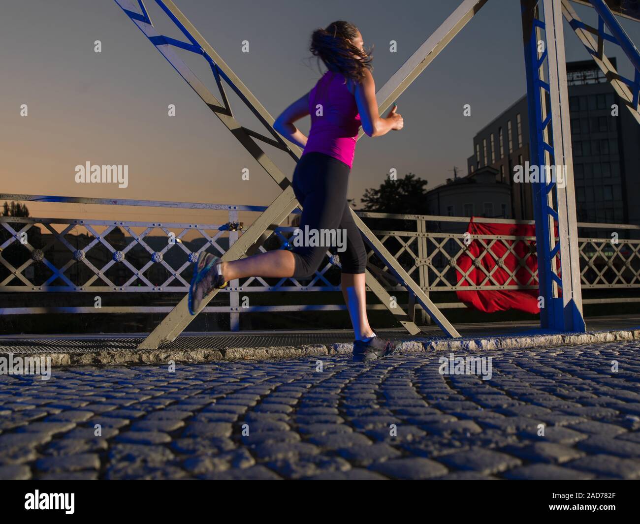 Woman jogging across bridge hi-res stock photography and images - Alamy