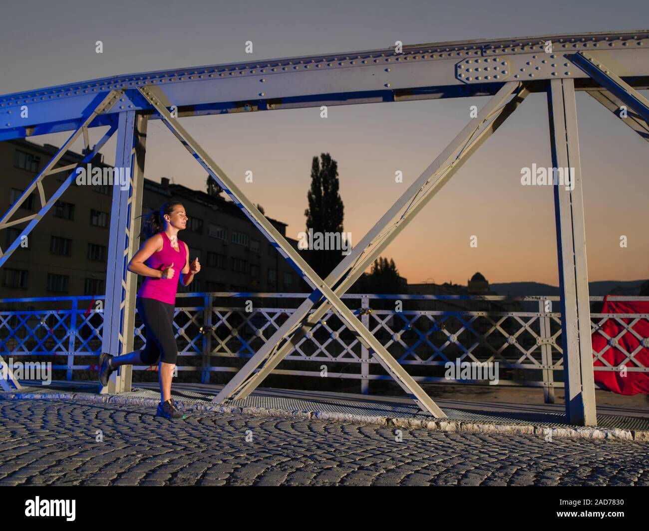 Woman jogging across bridge hi-res stock photography and images - Alamy
