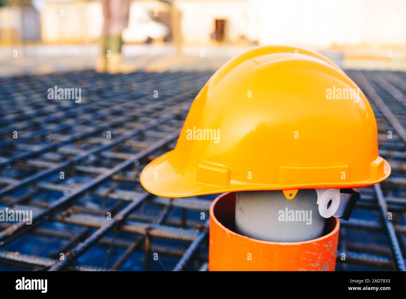 Orange safety helmet at construction site with blurry background Stock ...