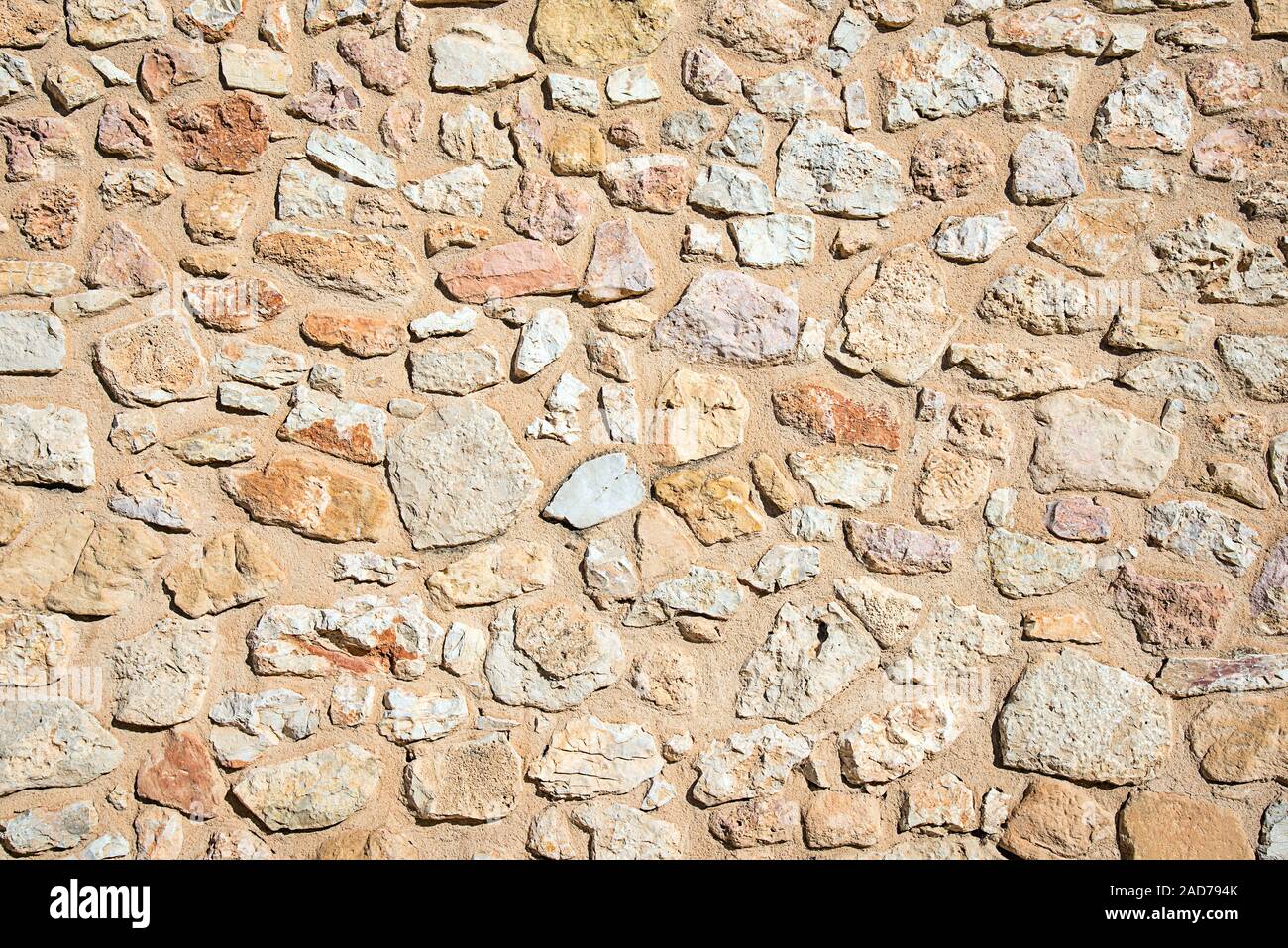 Background from a rough wall made of natural stone Stock Photo - Alamy