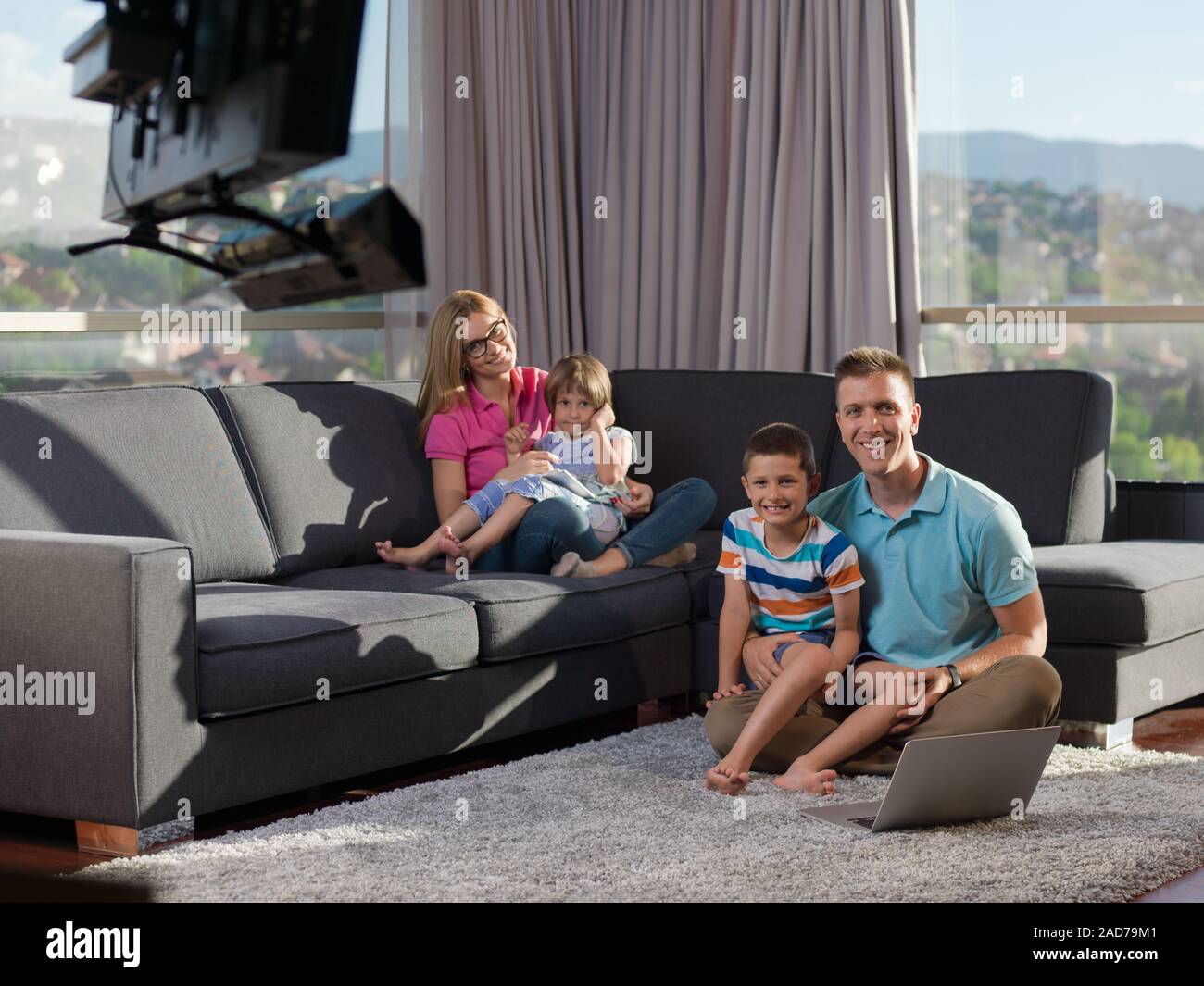 young happy family relaxing at home Stock Photo - Alamy