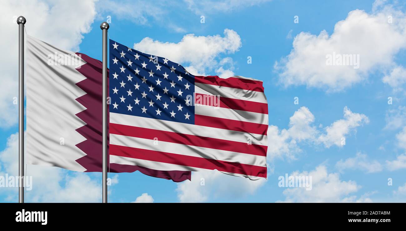 Qatar and United States flag waving in the wind against white cloudy ...
