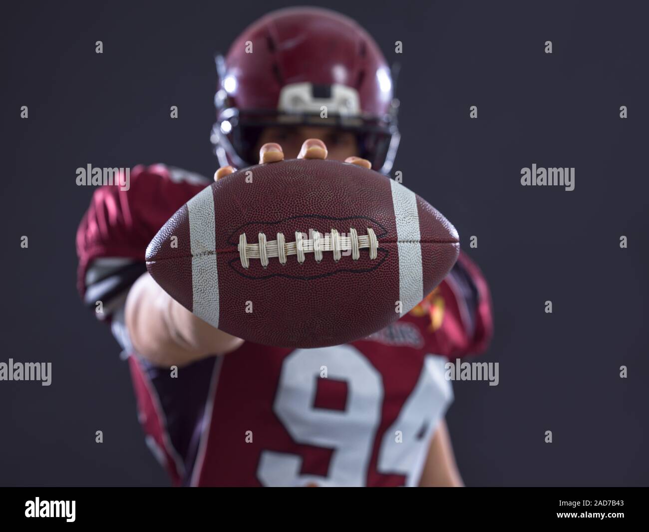 american football player showing football to camera Stock Photo - Alamy