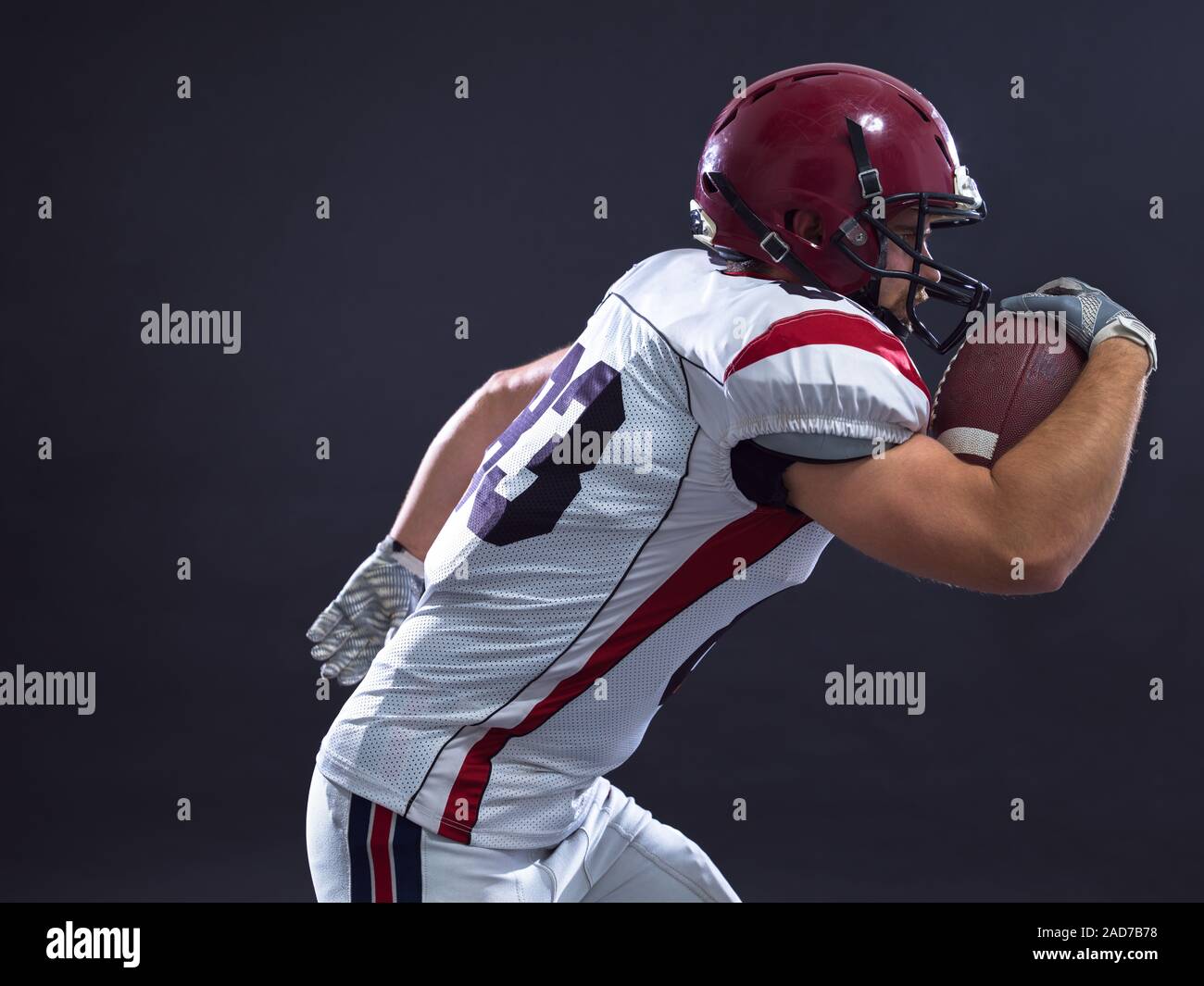 American football Player running with the ball Stock Photo - Alamy